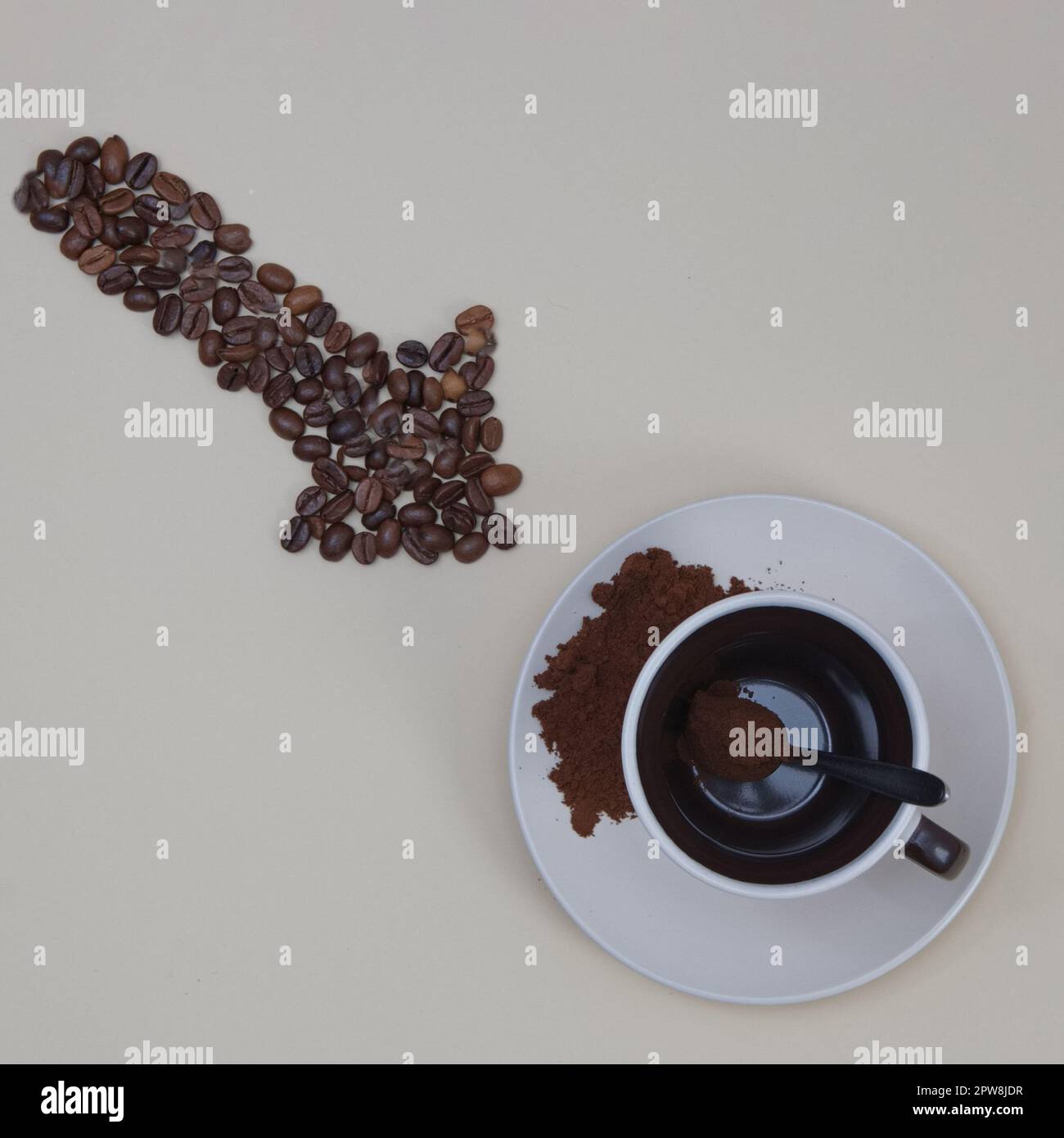Coffee cup, spoon, and coffee bean arrow with copy space on beige ...