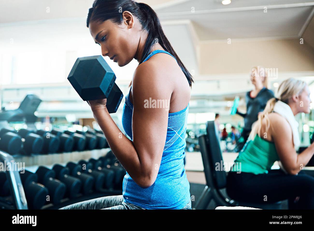 Girl power. attractive young women working out with dumbbells at the ...