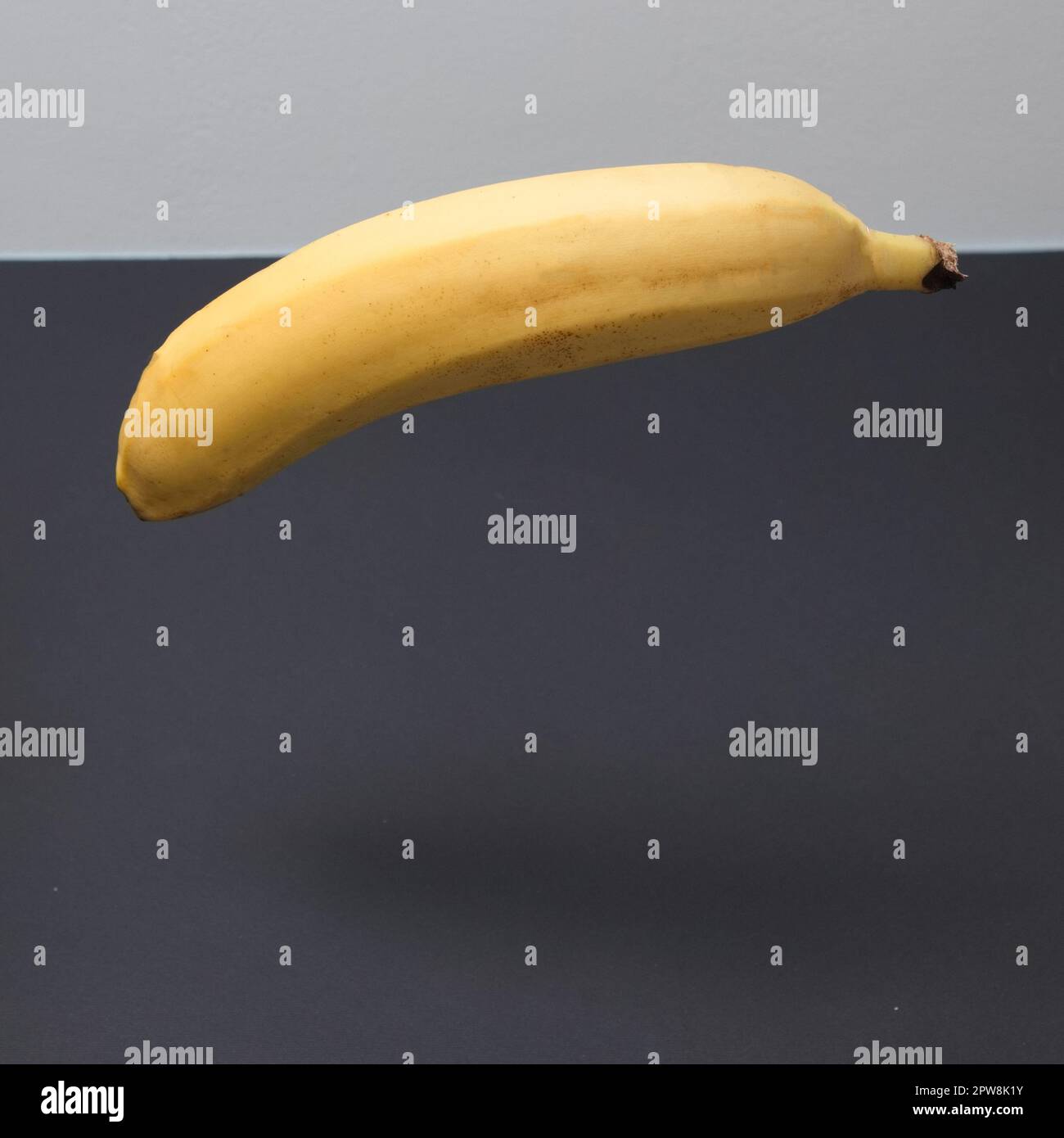 A levitating banana with copy space on a black and white background ...