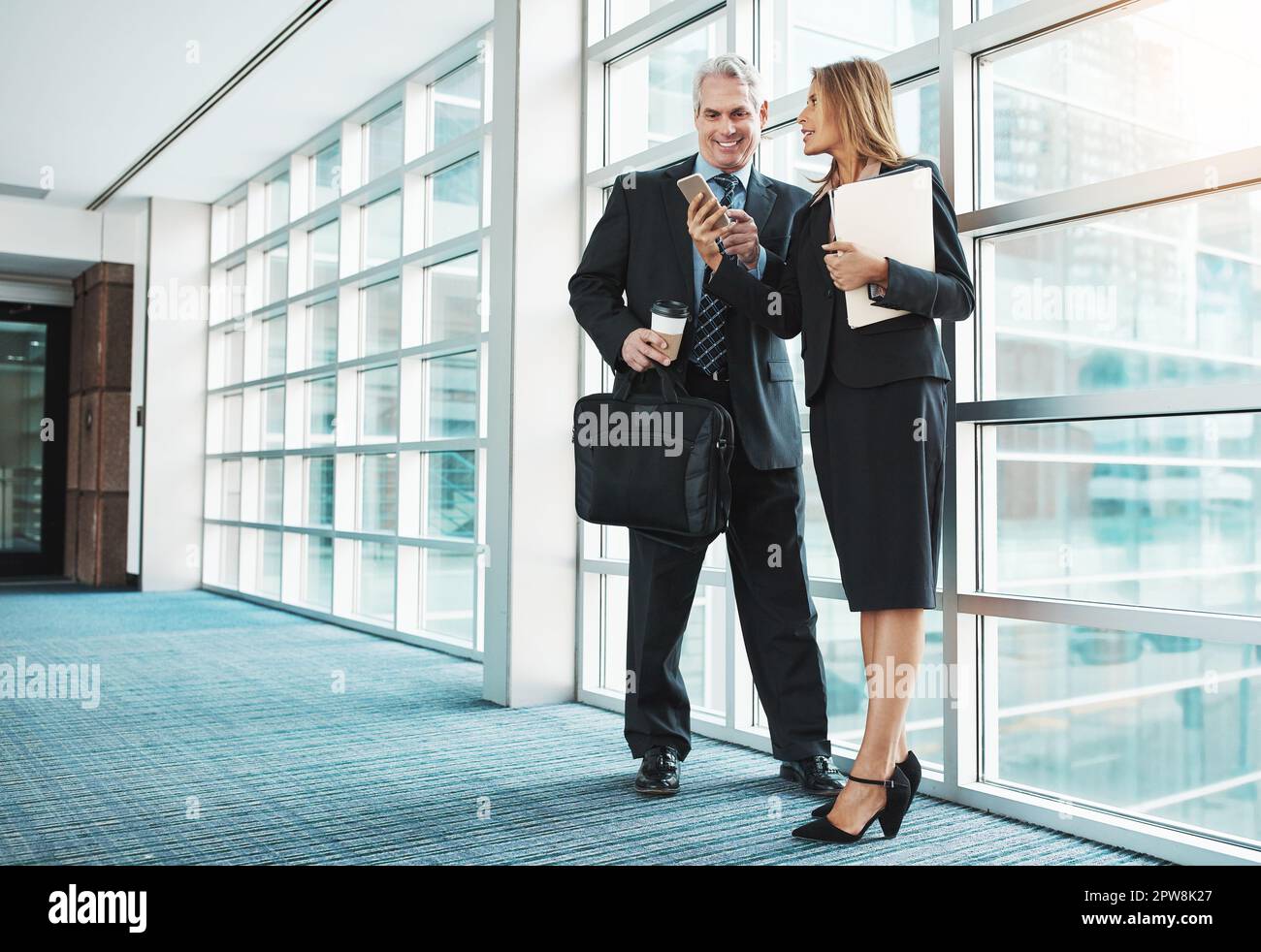 Co-ordinating their schedules using smart technology. a businessman and ...