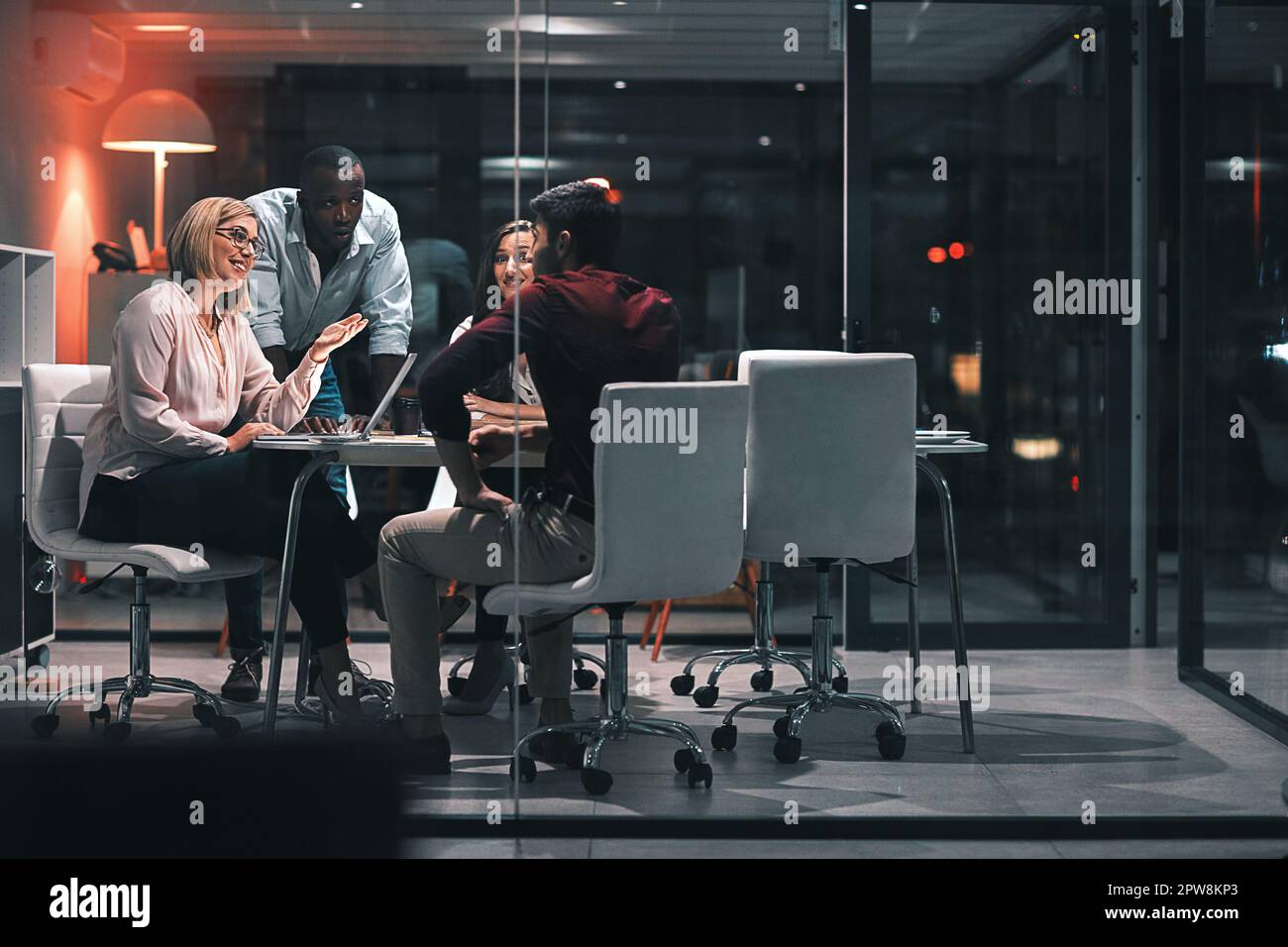 Boosting productivity with overtime. colleagues having a meeting during ...