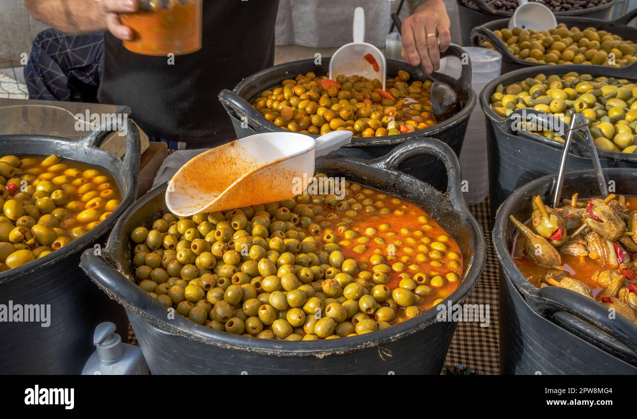 Wide selection of olives at a food stall a traditional market on a ...