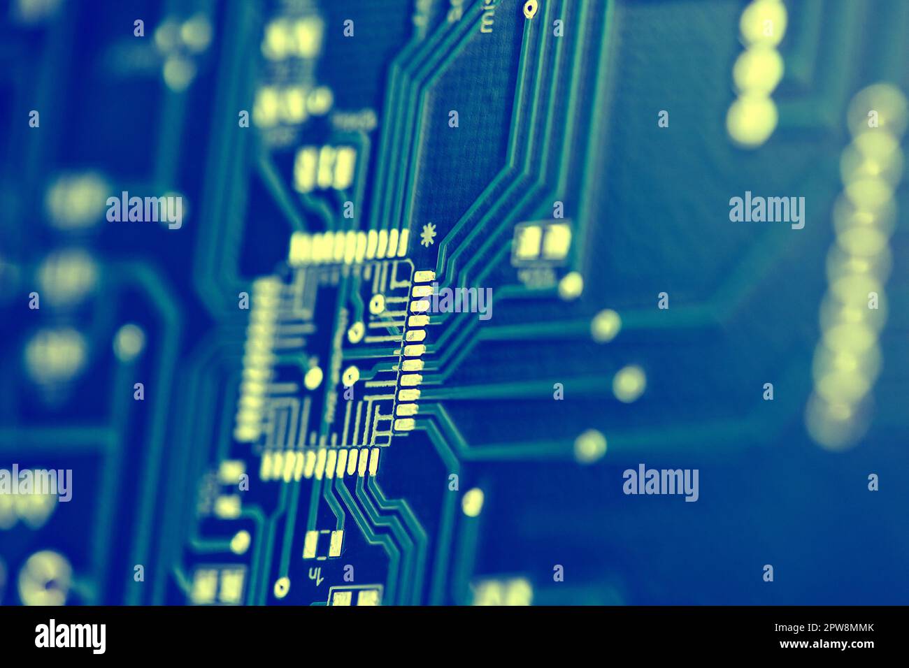 Macro shot of the back side of a circuit board. Close up of the blue ...