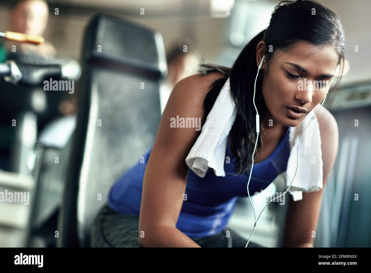 Feeling the post workout effects. a young woman taking a break from her ...