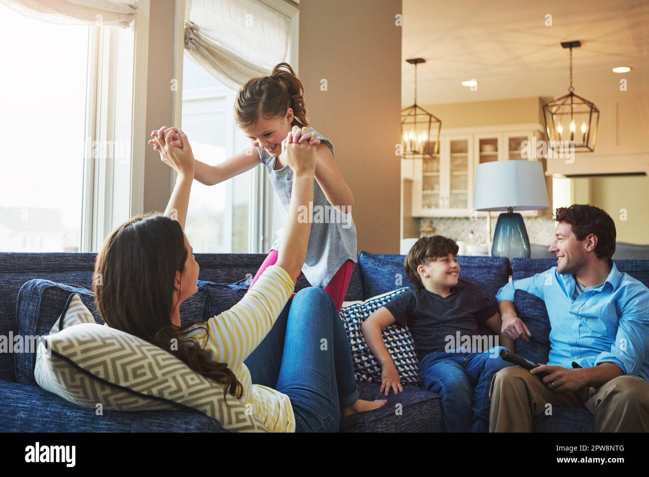 The joys of family life. a happy family bonding together at home Stock ...