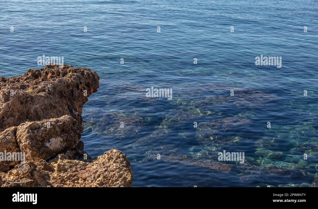 Rock over the sea. View from high rock of transparent sparkle calm sea ...