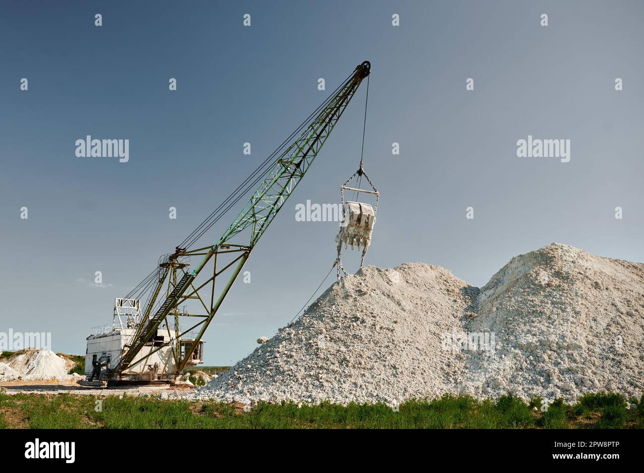 Walking excavator in process of chalk mining in open quarry Stock Photo ...