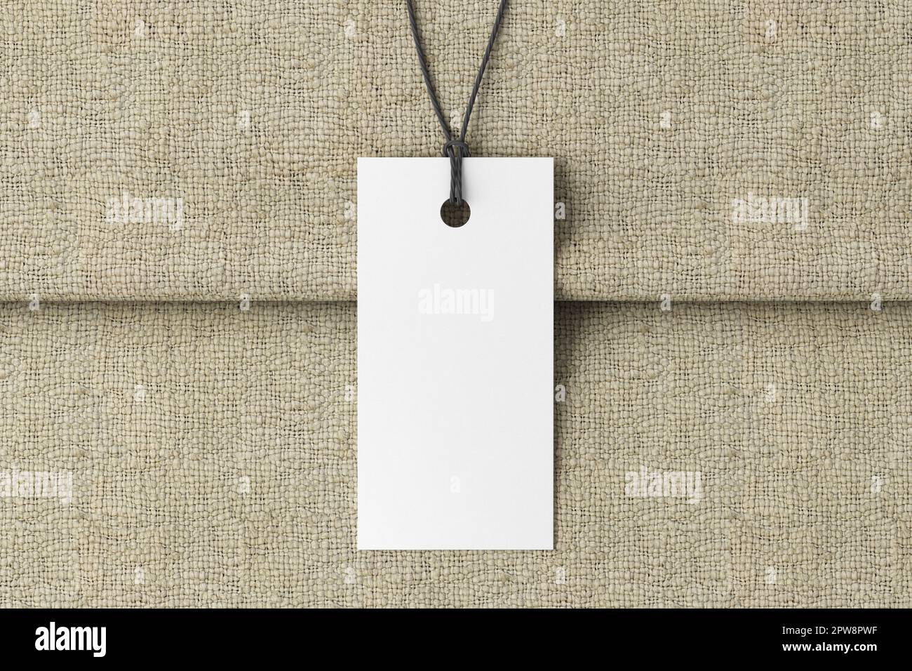 White rectangular tag mockup on fabric background. View directly above ...