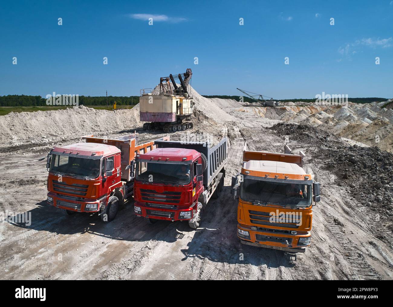 Red tipper trucks and shovel mining excavator in mining quarry Stock ...