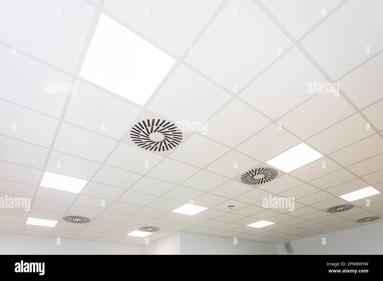 View from the bottom of the suspended panel ceiling with lights on ...