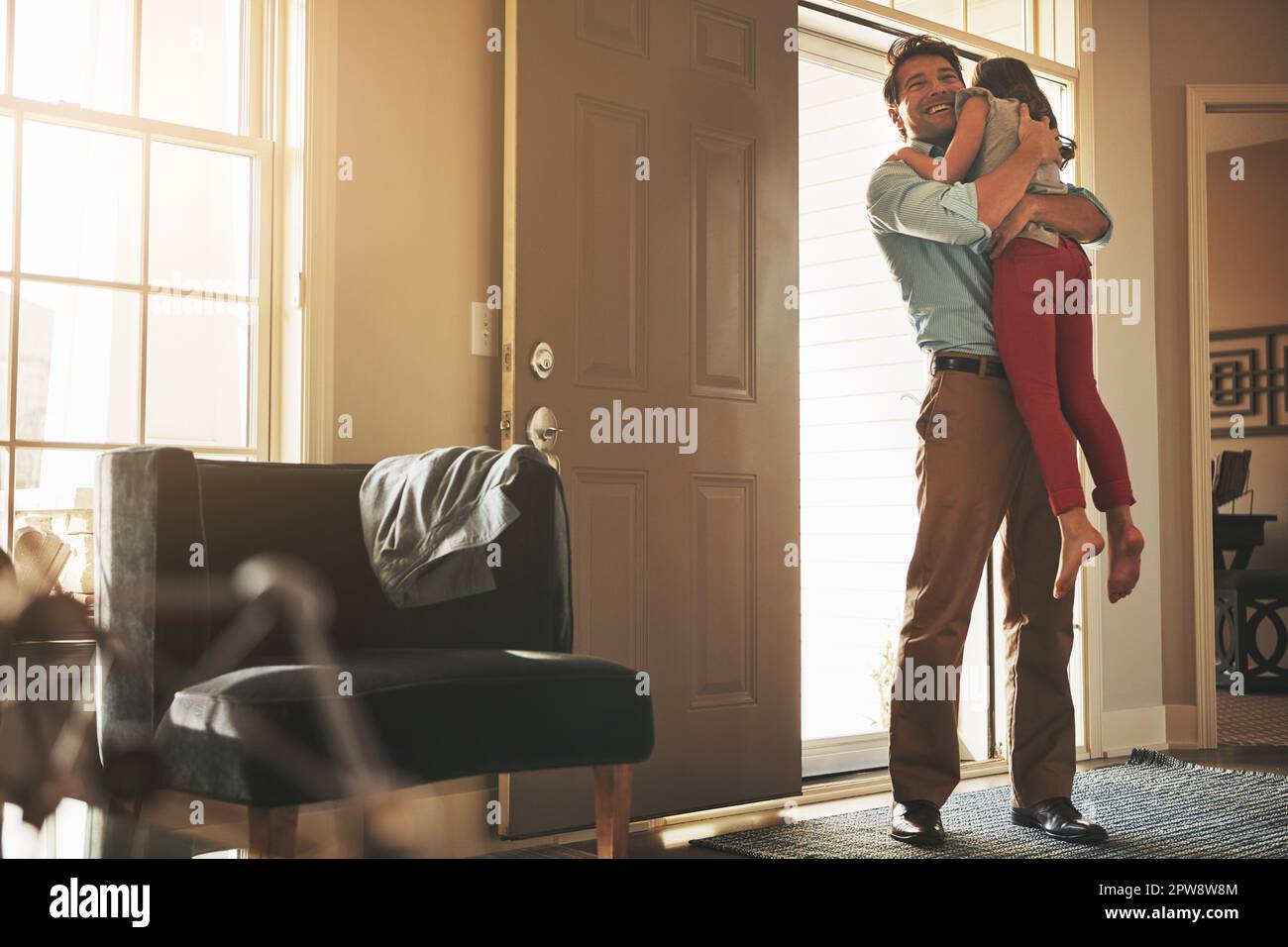 Returning home to a joyful reunion. a happy father arriving home to a ...