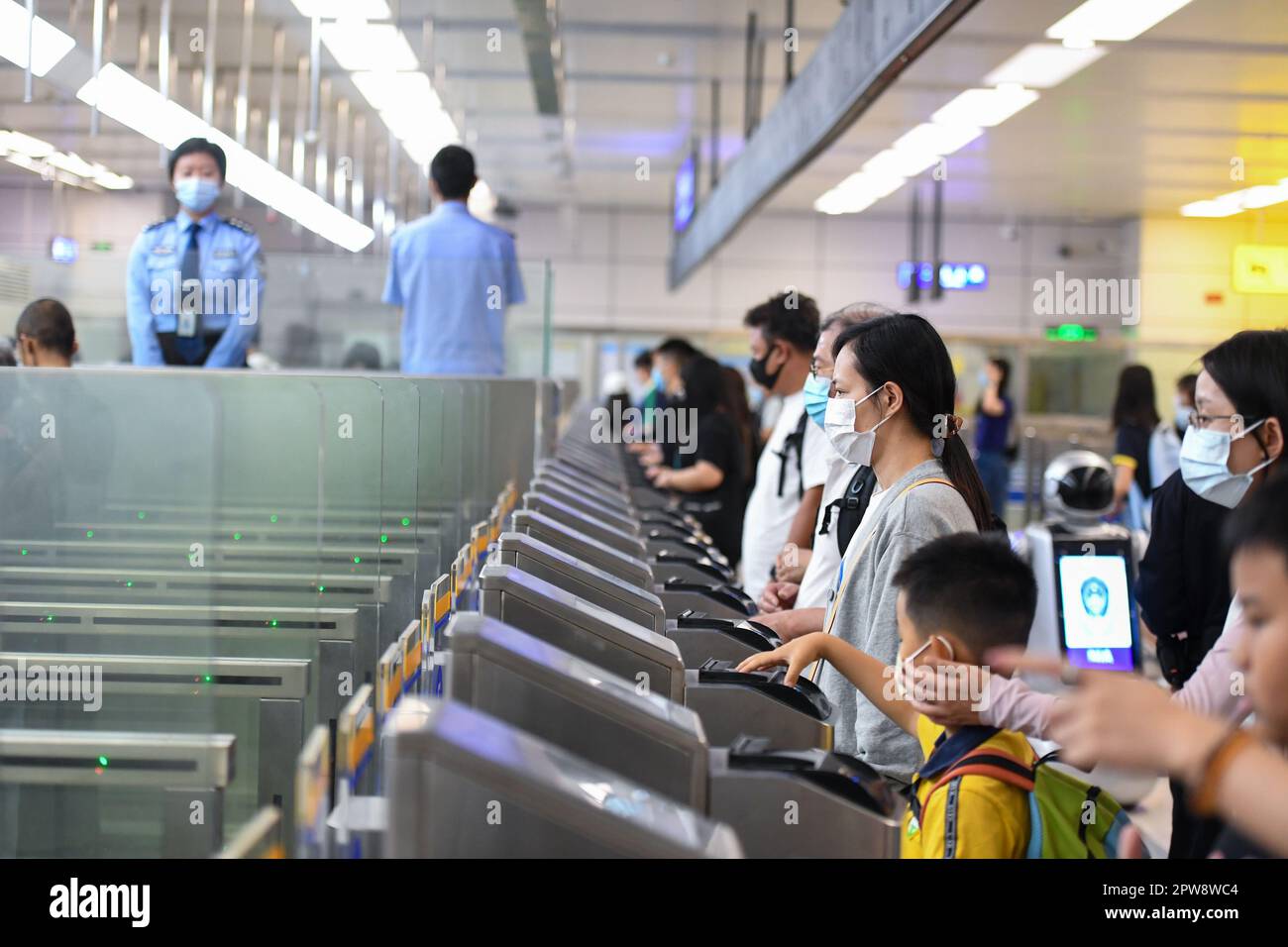 Shenzhen, China's Guangdong Province. 29th Apr, 2023. Travelers walk ...