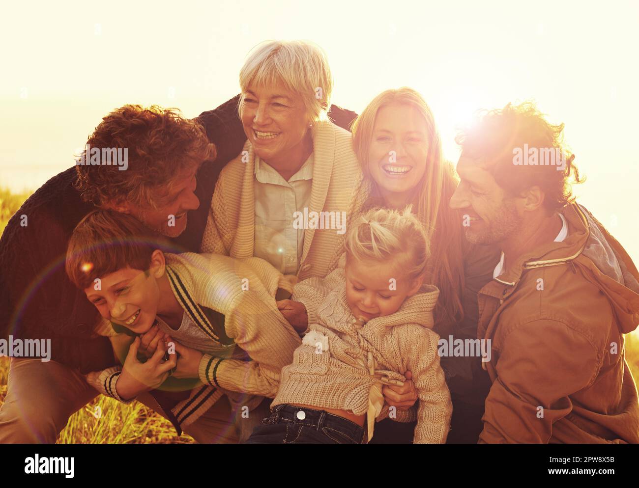 Happy, love and big family in nature at sunset hugging, bonding and ...