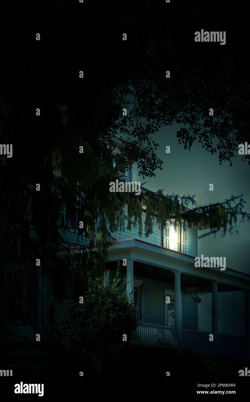 Weatherboard House with Lit Window Stock Photo - Alamy