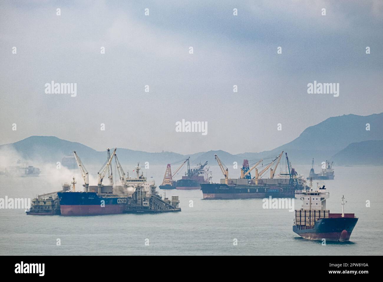 Hong Kong, China. 29th Apr, 2023. Sand cargo ships are seen in between ...