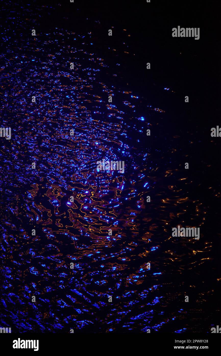 Light Reflecting off Rippled Water at Night Stock Photo - Alamy