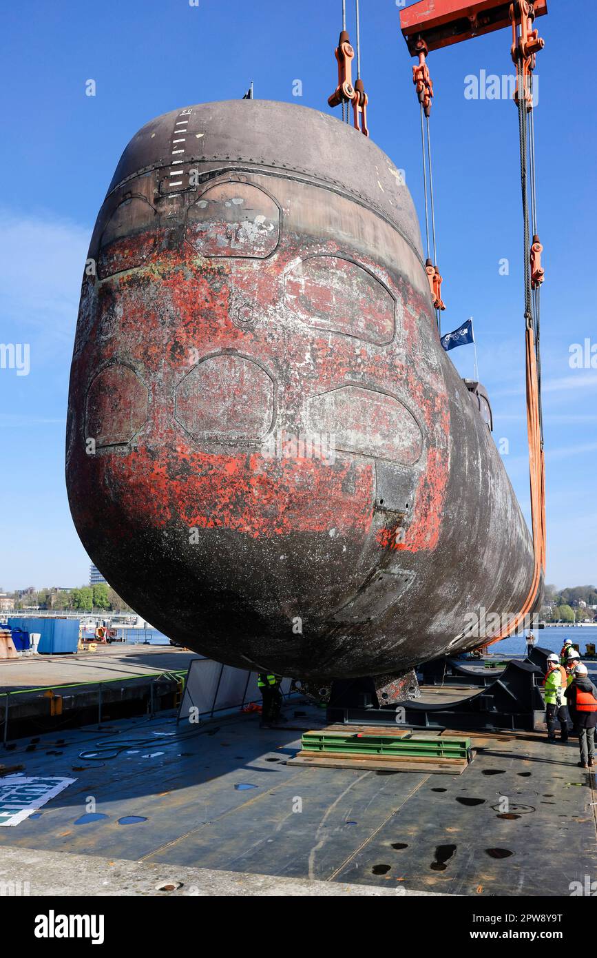 Kiel, Germany. 28th Apr, 2023. The submarine U17 is loaded onto a ...