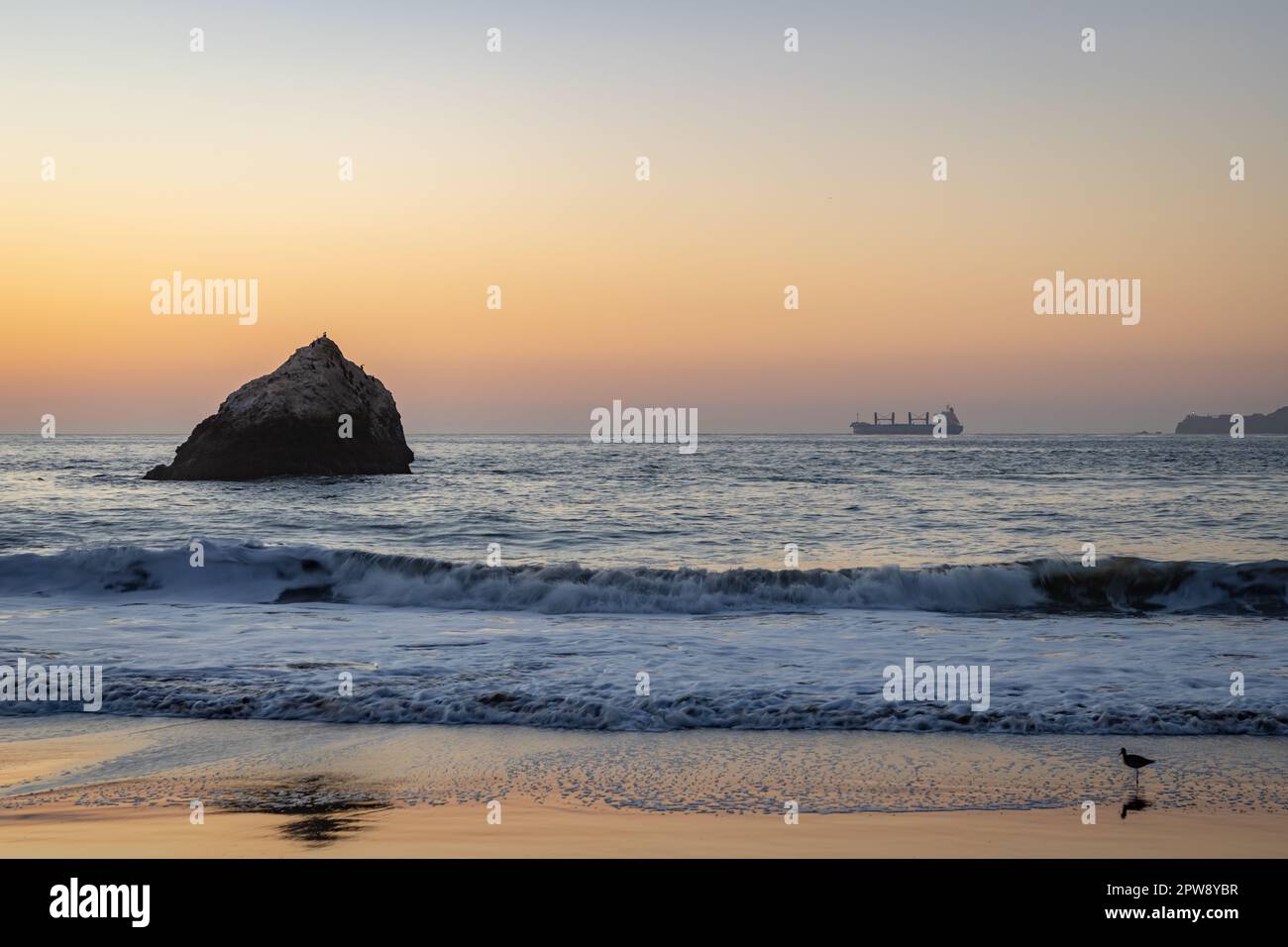 A picture of the sun setting over the Golden Gate strait and Baker ...