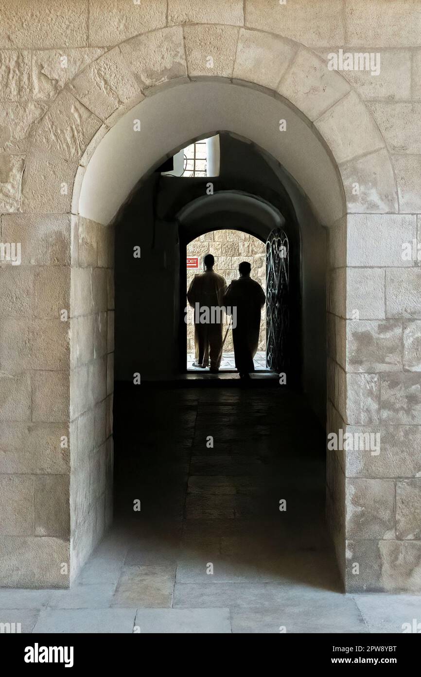 Two priests in an arched passageway in the old city of Jerusalem ...