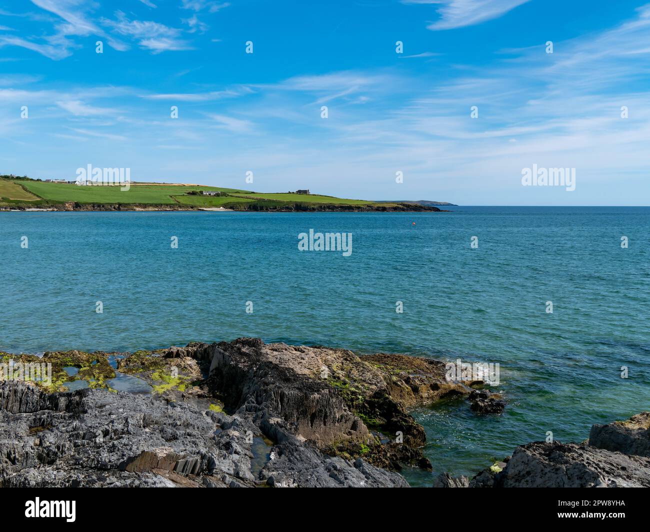 The rocky Irish coast on a sunny summer day. Blue sea water under a ...