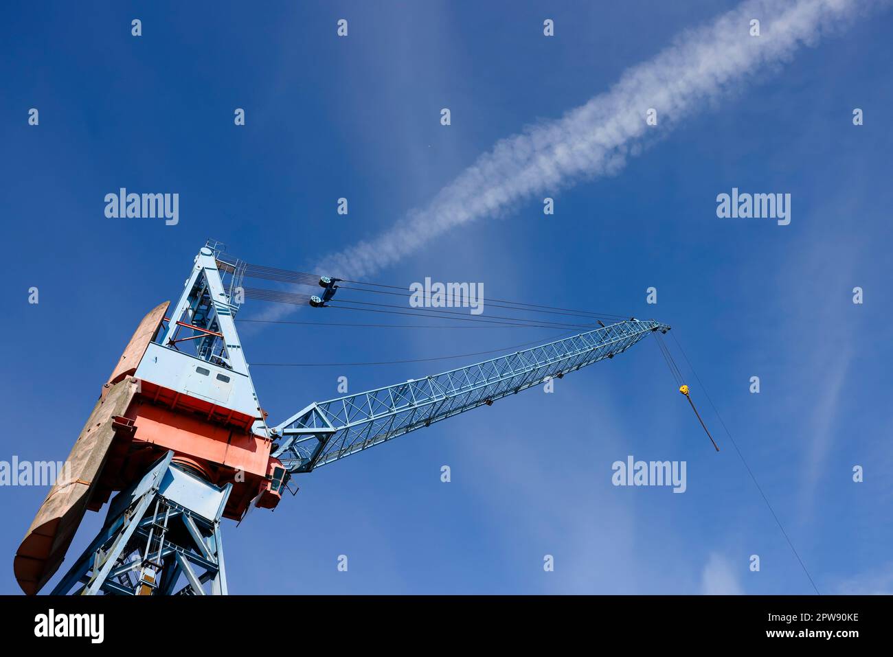 Kiel, Germany. 28th Apr, 2023. A crane is in operation while the ...