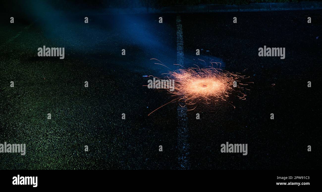 Yellow ground fireworks on asphalt Stock Photo - Alamy