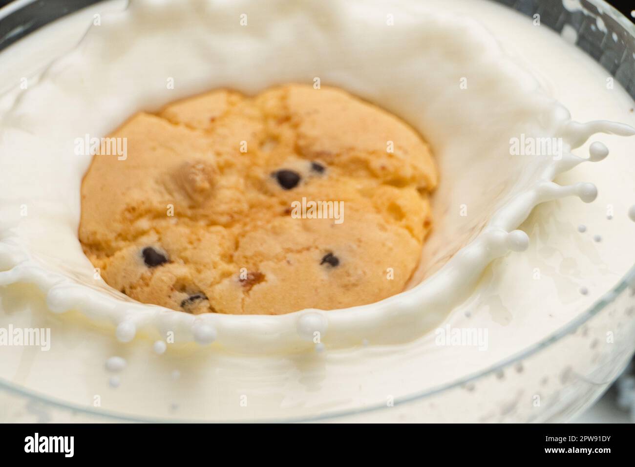 Chocolate falling in milk splashing hi-res stock photography and images ...