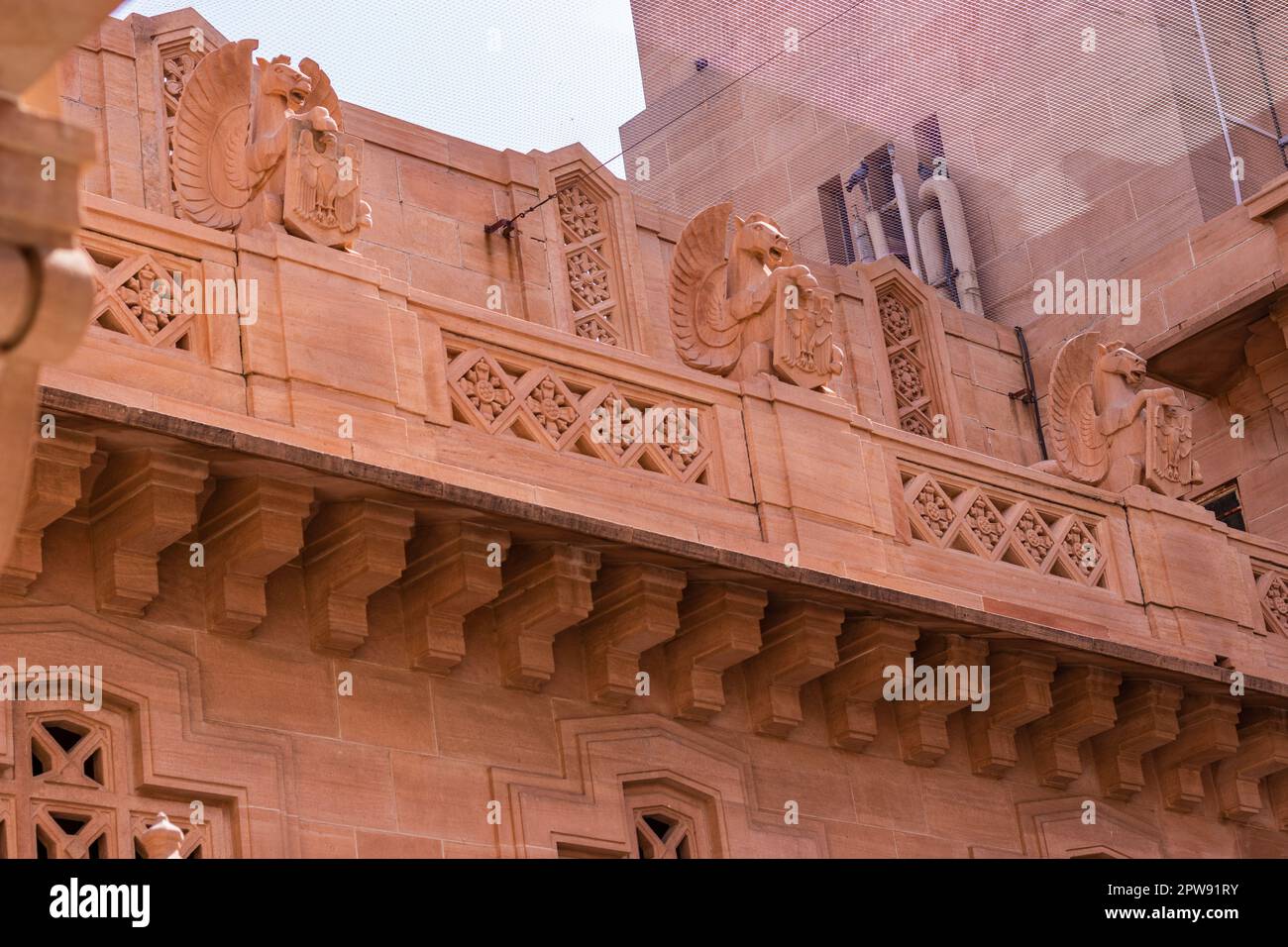 artistic design of palace wall made of red stone at day from flat angle ...