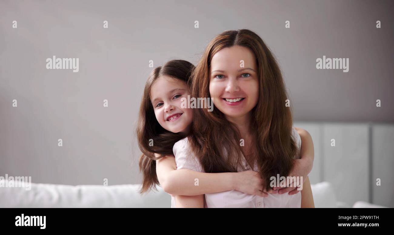 Happy Mom Embracing Smiling Child. Kid Hug Stock Photo - Alamy