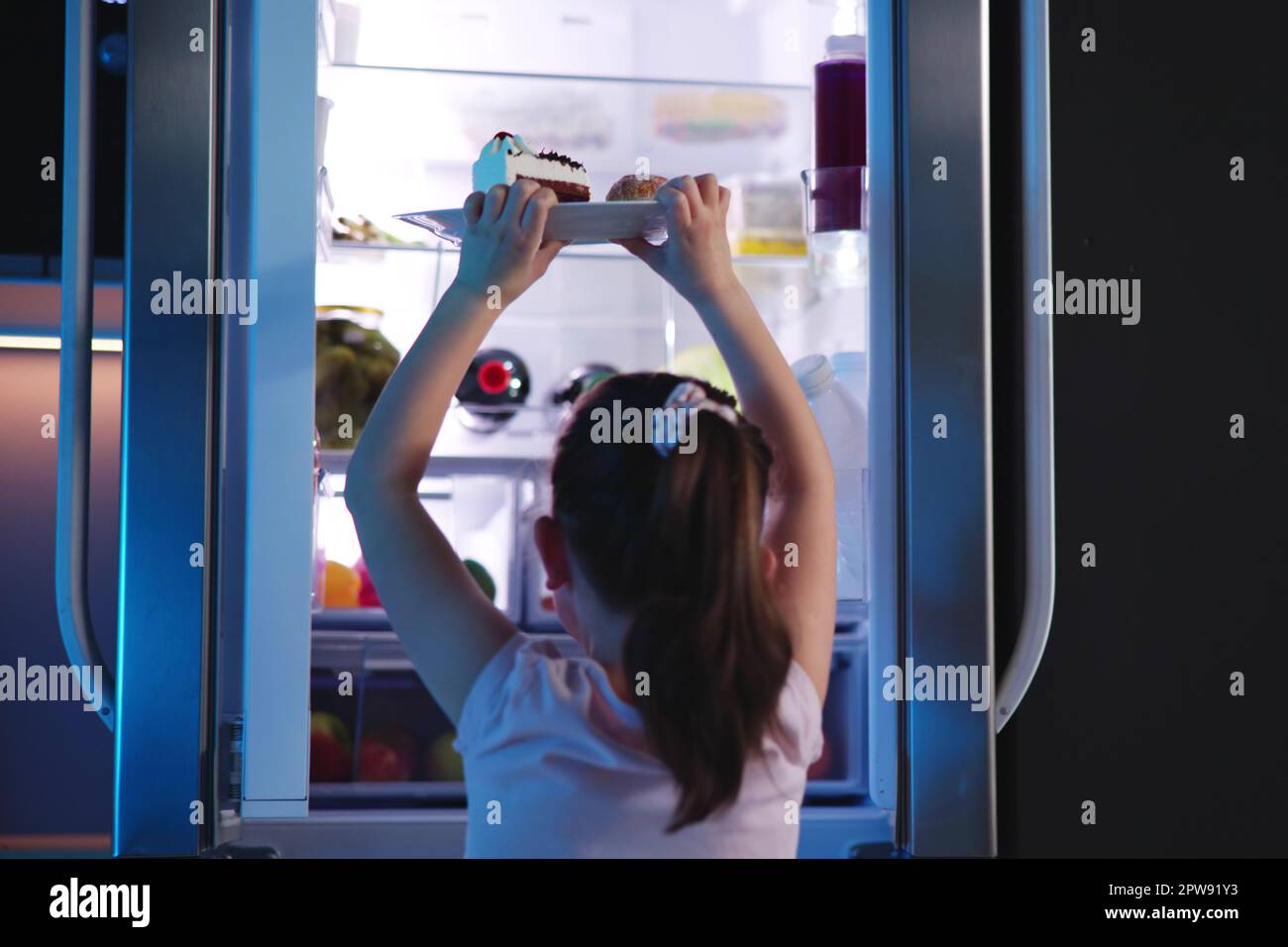 Child Girl Taking Food Fridge At Night Stock Photo - Alamy
