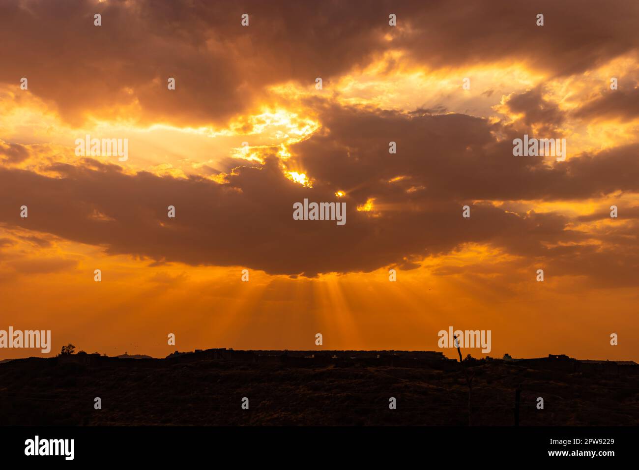 sunset dramatic sky with sun beams with dark clouds at dusk Stock Photo ...