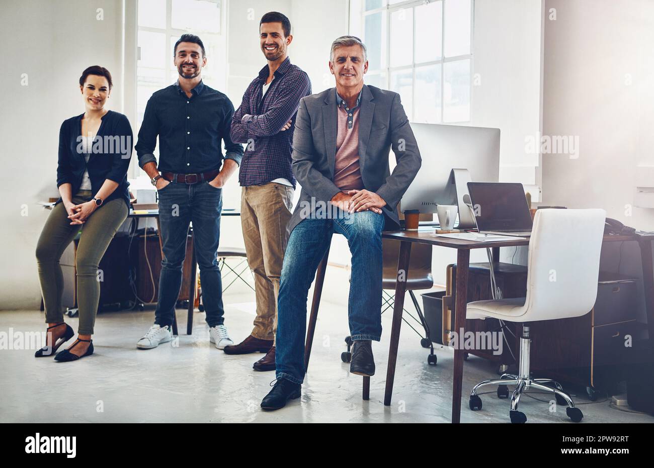 Together we ignite new levels of creativity. Portrait of a team of ...