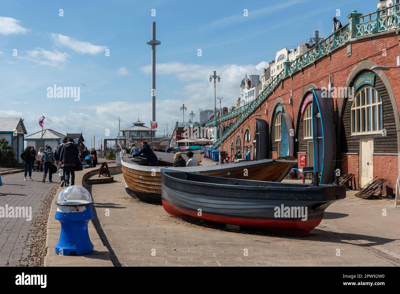 A walk along the seafront at Brighton, with boats and coffee shops ...
