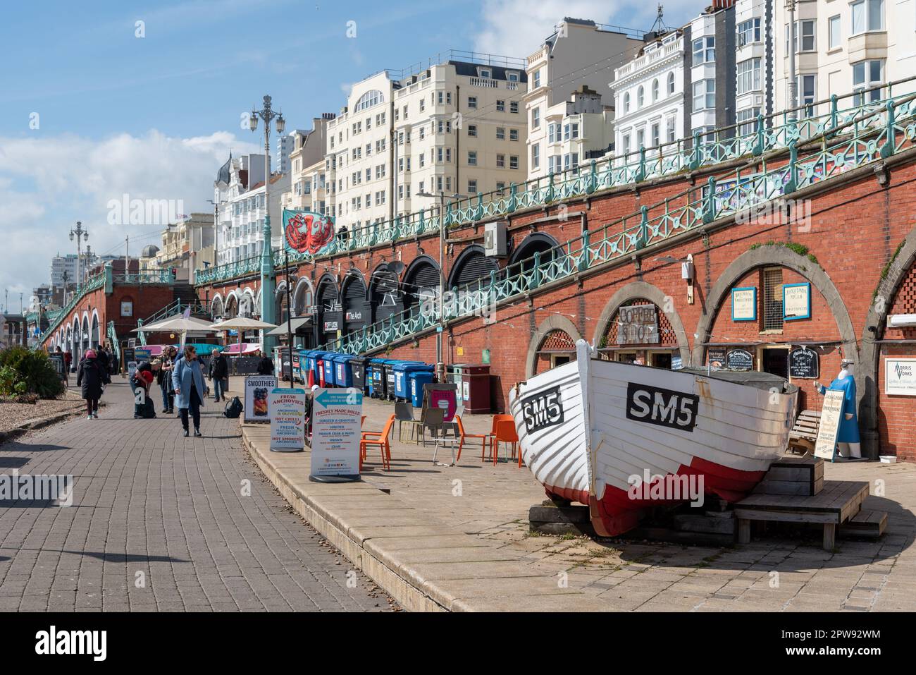 A walk along the seafront at Brighton, with boats and coffee shops ...