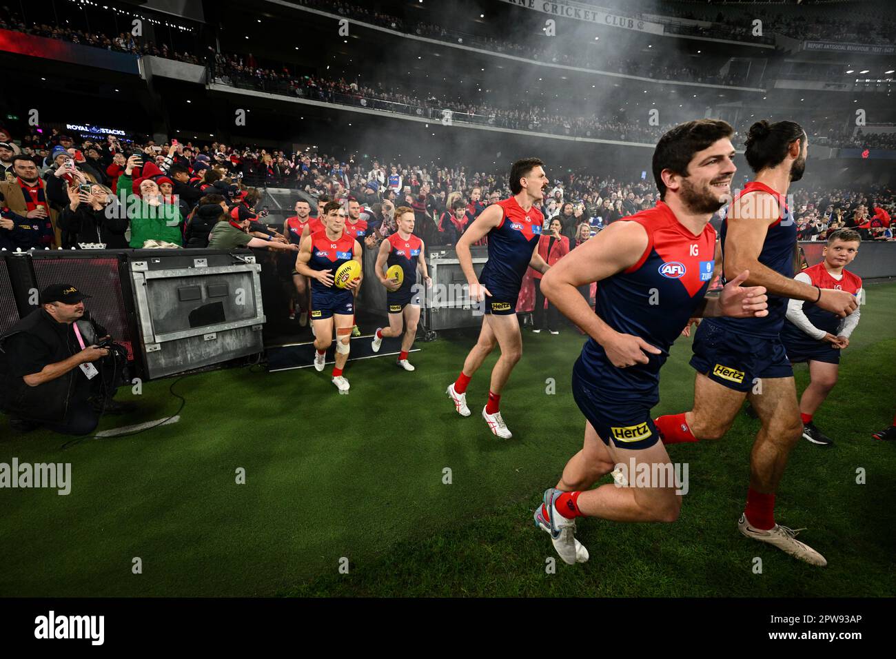 Melbourne Demons players take the field during the AFL Round 7 match ...
