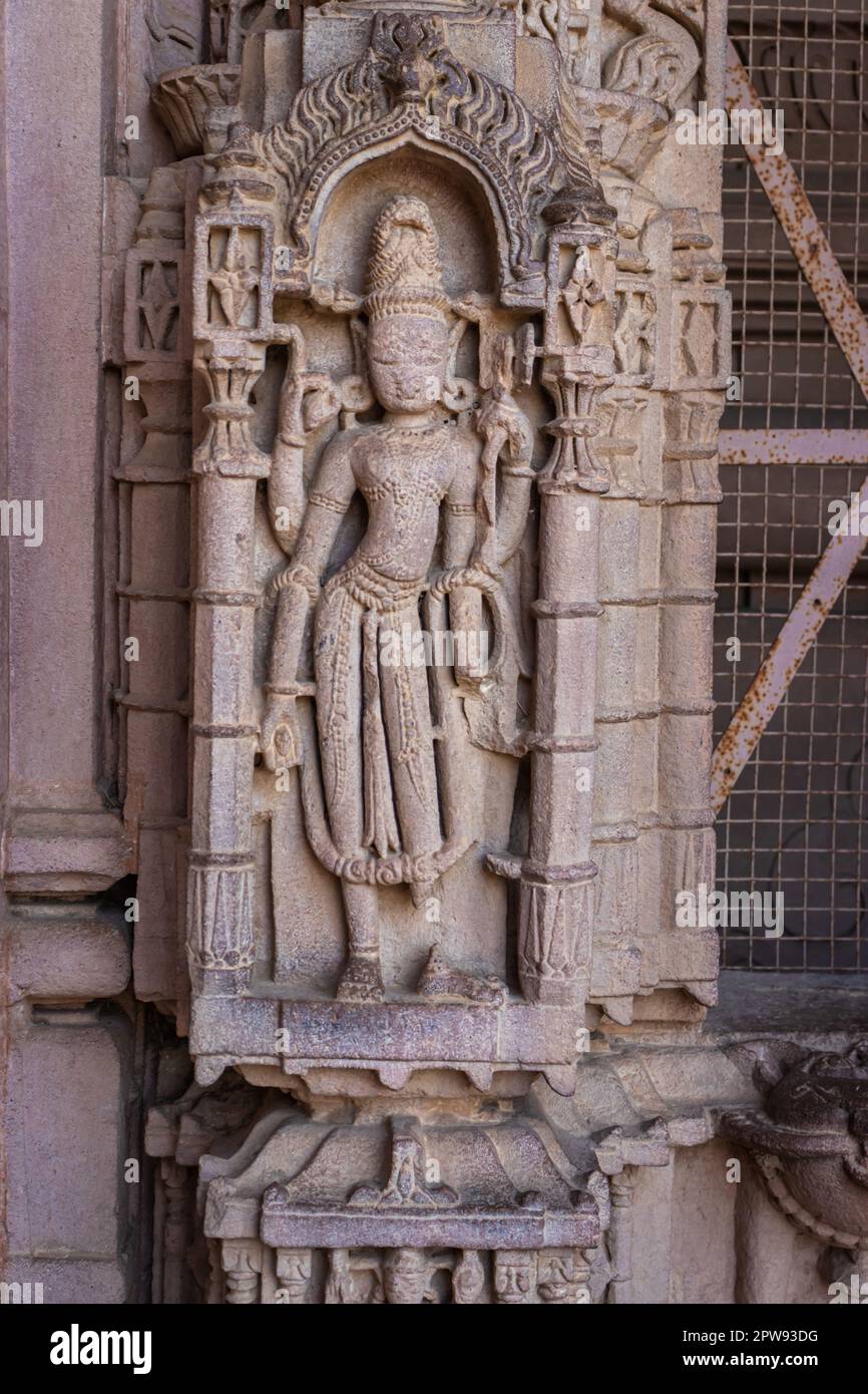 hindu god unique idol engraved art on temple wall from flat angle at ...