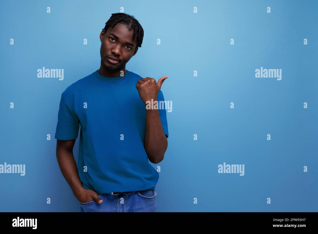 energetic young black american man pointing at wall over isolated ...