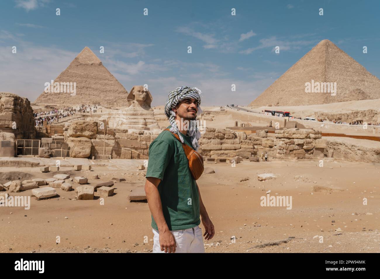 young man in a turban with great sphinx of Giza and pyramids in the ...