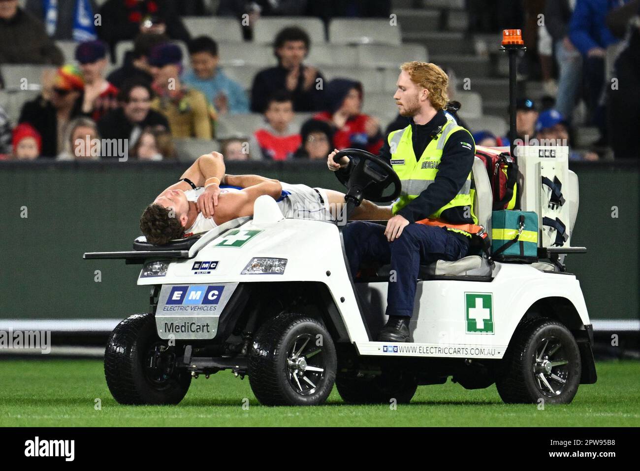 Charlie Comben of North Melbourne is treated for an injury during the ...