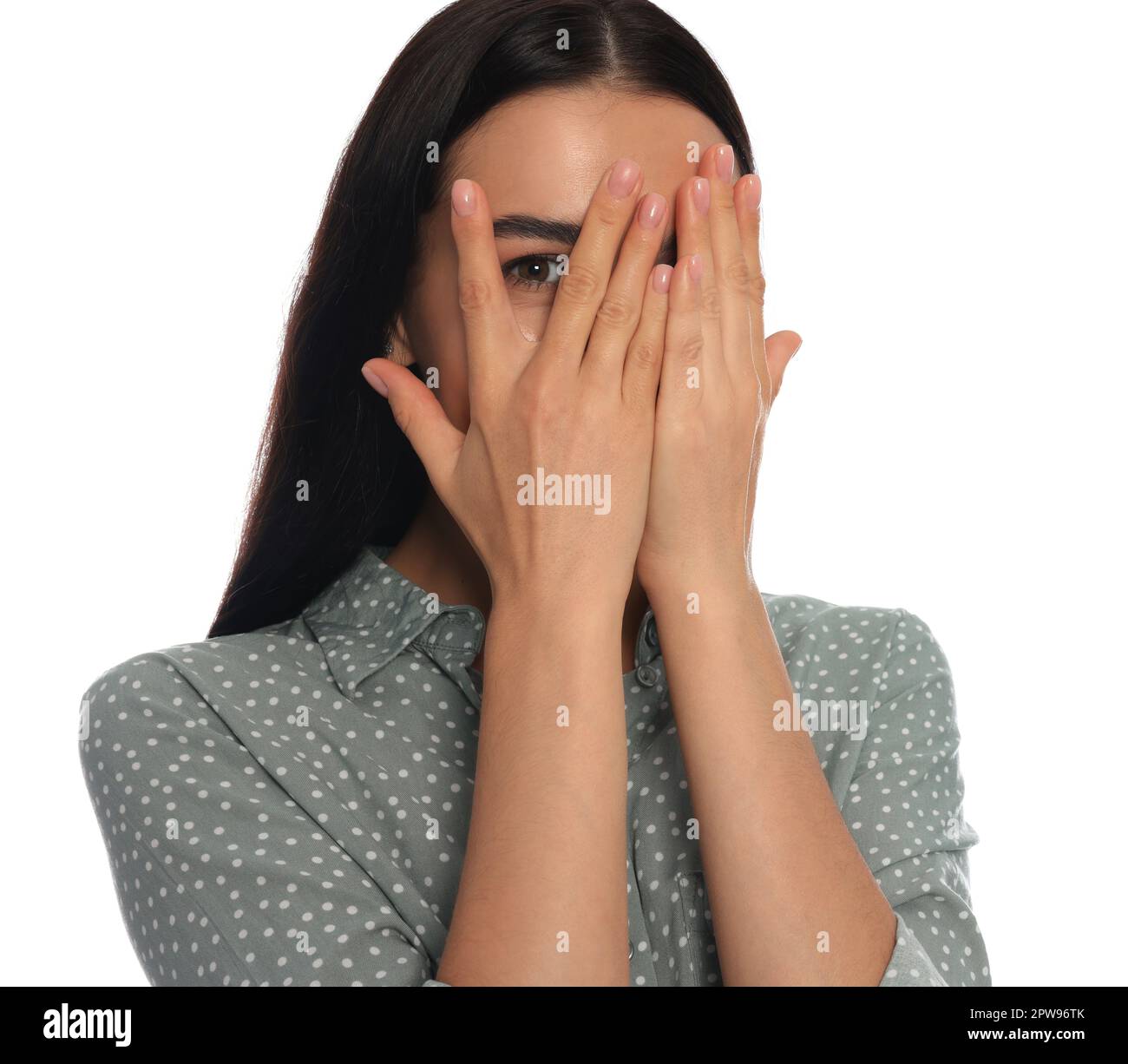 Embarrassed young woman covering face with hands on white background ...