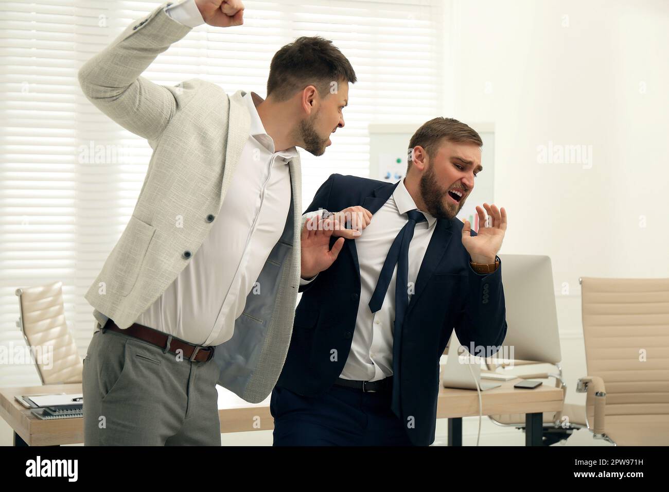 Emotional colleagues fighting in office. Workplace conflict Stock Photo ...