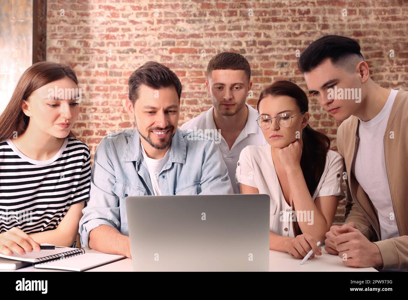 Team of employees working together in office Stock Photo - Alamy