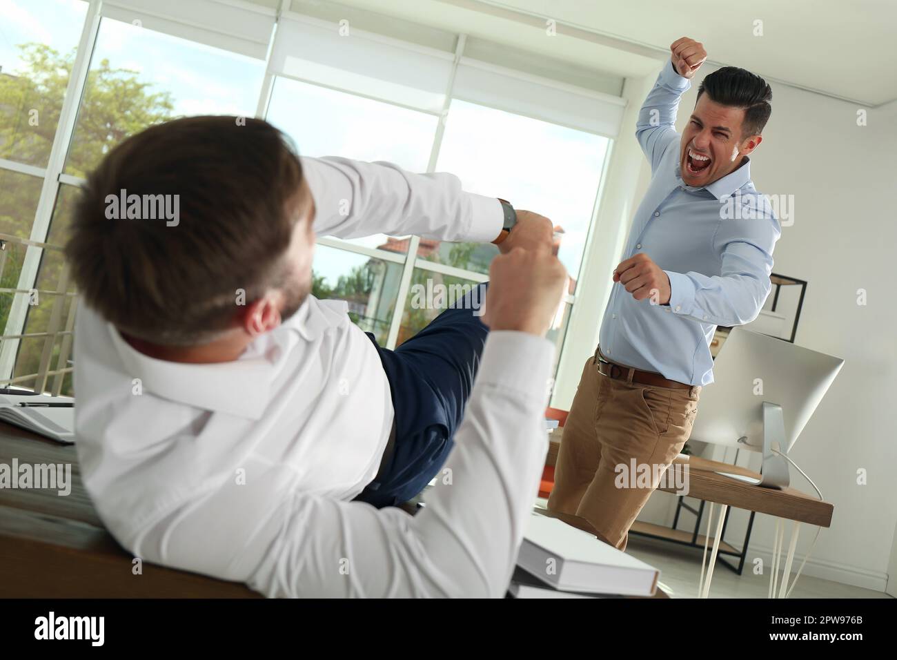 Emotional colleagues fighting in office. Workplace conflict Stock Photo ...