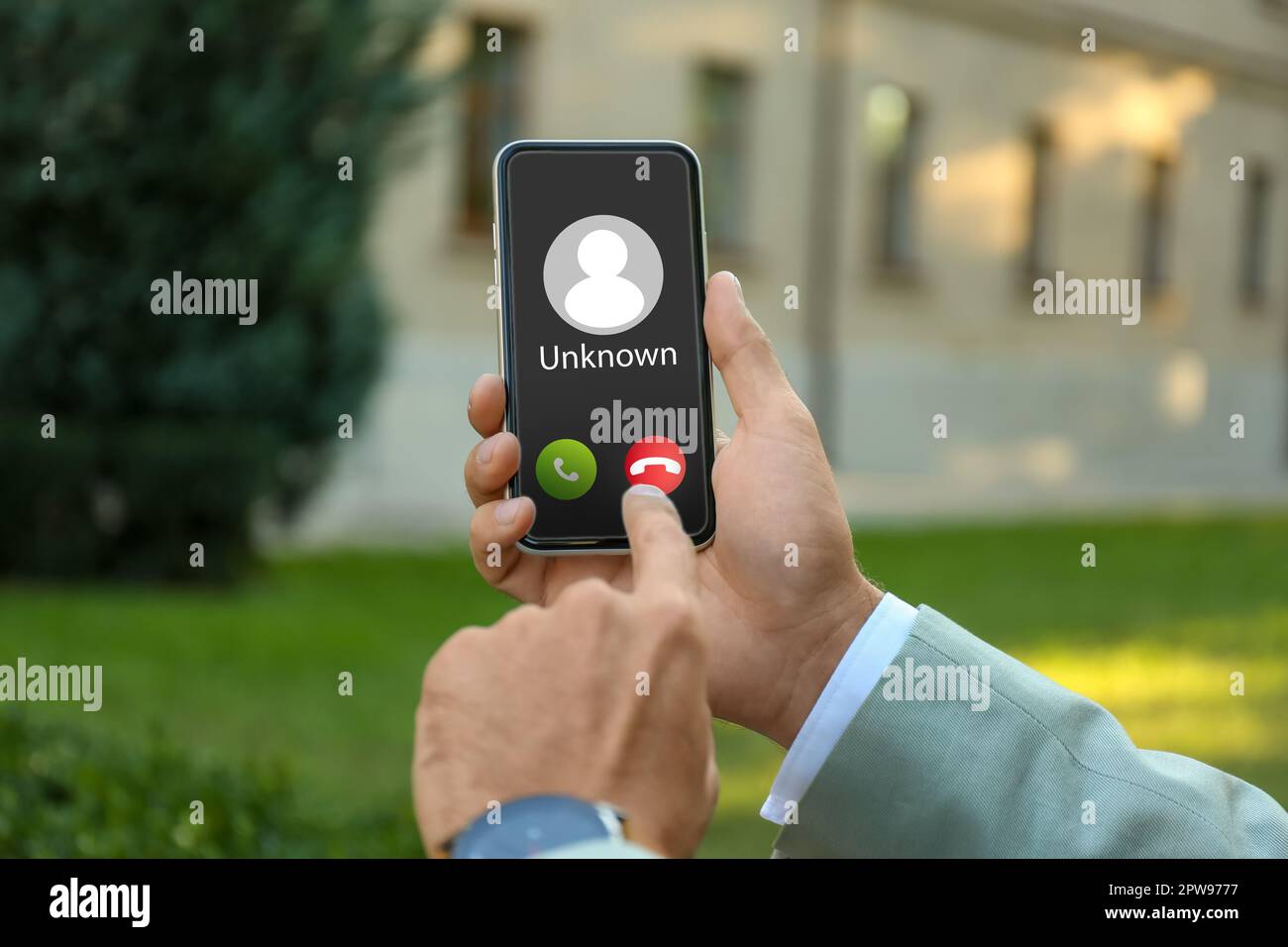 Man declining incoming call from unknown caller outdoors, closeup. Be ...