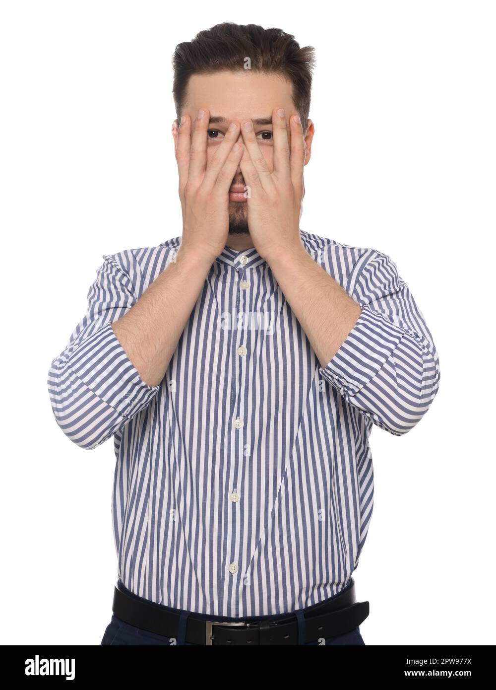 Embarrassed man covering face with hands on white background Stock Photo - Alamy