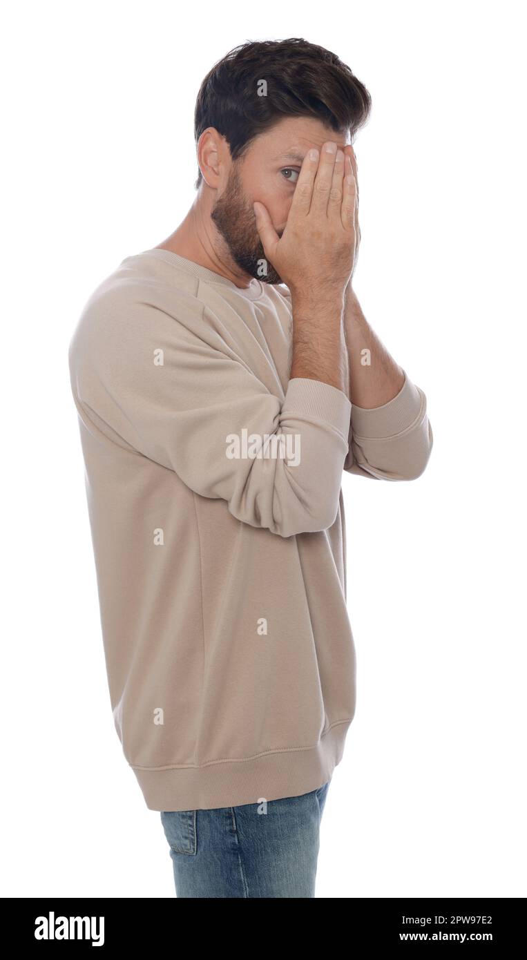 Embarrassed man covering face with hands on white background Stock ...