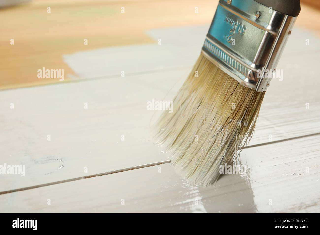 Applying white paint onto wooden surface, closeup. Space for text Stock ...