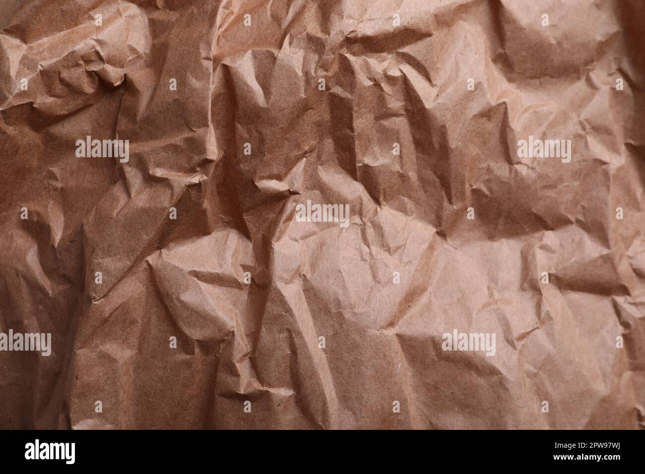 Texture of wrinkled kraft paper bag as background, closeup Stock Photo ...
