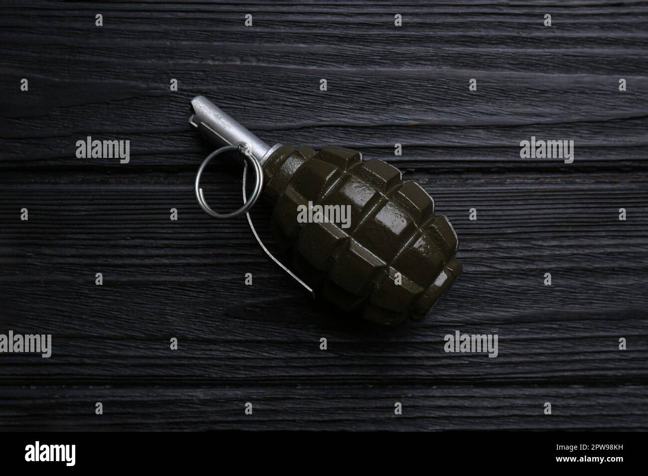 Hand grenade on black wooden table, top view Stock Photo - Alamy