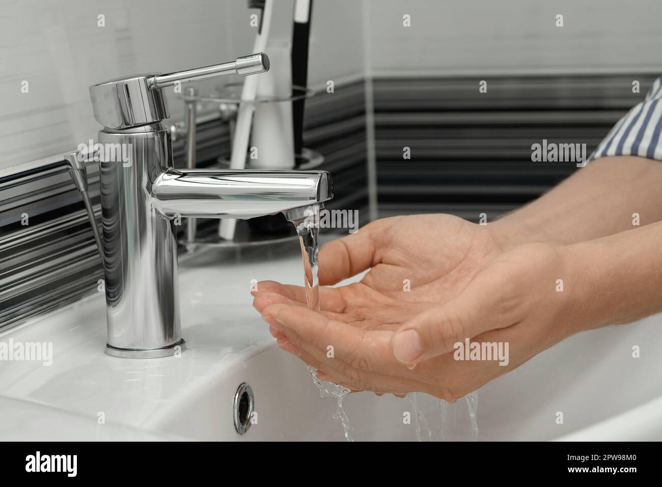 Person rinsing hands in bathroom hi-res stock photography and images ...